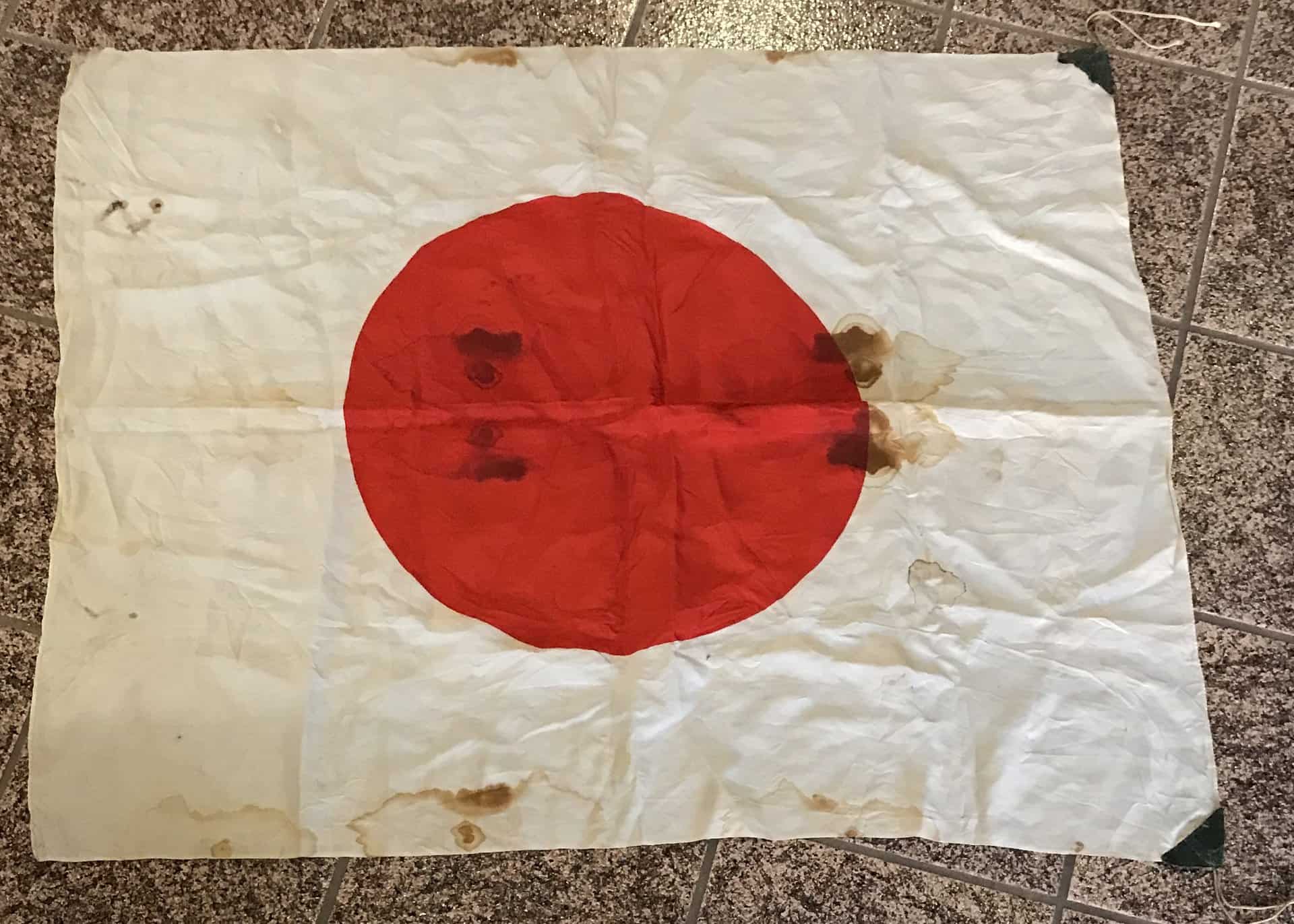 Explore WWII Blood Stained Japanese Flag Relic from Veteran